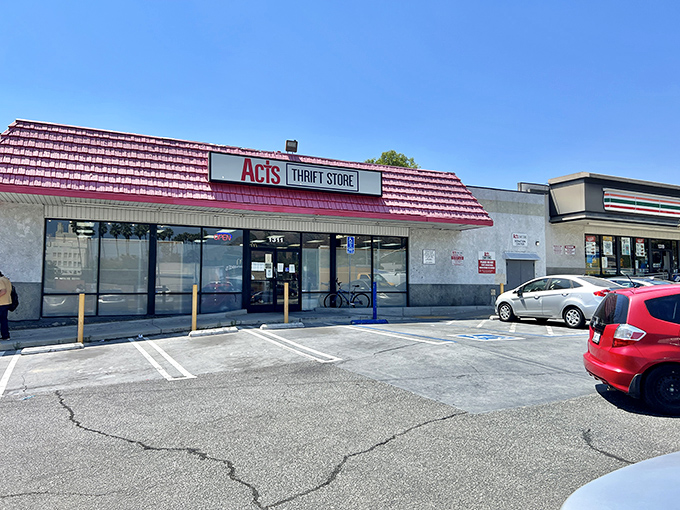 The iconic red roof of ACTS Thrift Store beckons bargain hunters like a lighthouse guiding ships to treasure-filled shores. Pasadena's best-kept secret hides in plain sight.