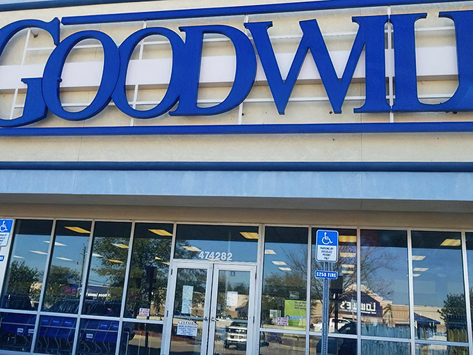 The iconic blue Goodwill sign beckons like a lighthouse for bargain hunters. This Jacksonville location promises treasures waiting to be discovered inside.