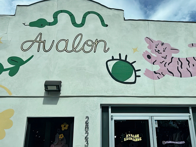Avalon Exchange's eye-catching storefront beckons with playful black illustrations and gold lettering. Fashion paradise awaits behind those glass doors.
