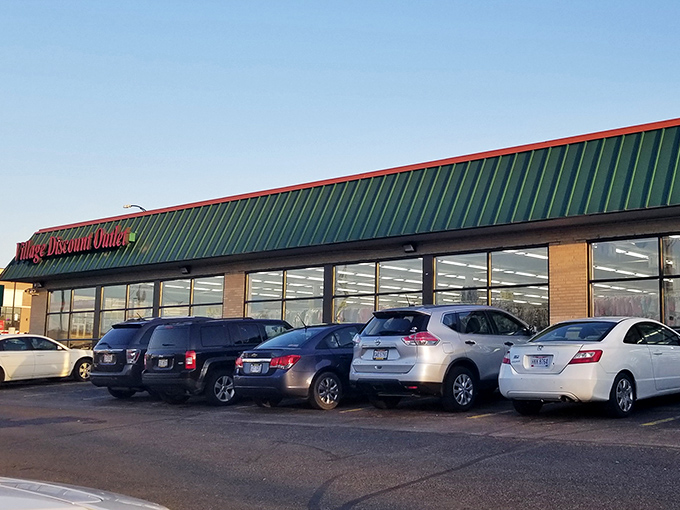 The iconic green roof and red signage of Village Discount Outlet&mdash;retail's version of finding money in your winter coat pocket.