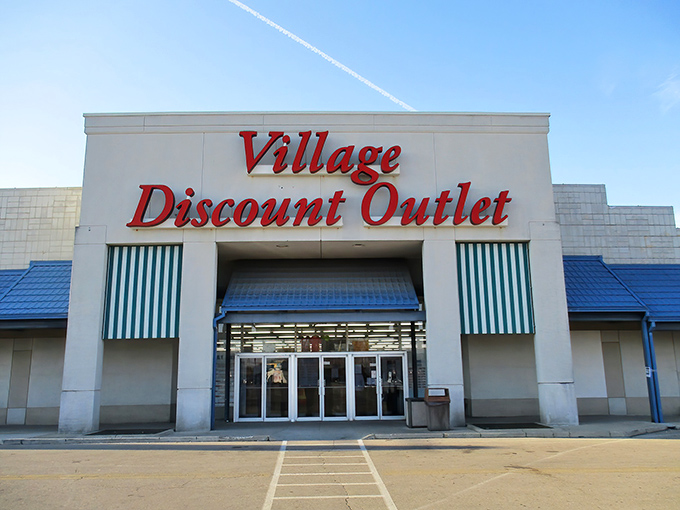 The iconic red signage of Village Discount Outlet stands out against the Dayton sky, a beacon for bargain hunters and treasure seekers alike.