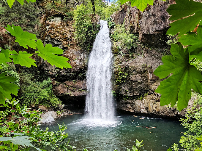 Nature's perfect curtain call: Potem Falls plunges 70 feet into an emerald pool, framed by maple leaves like nature's own theater curtains.