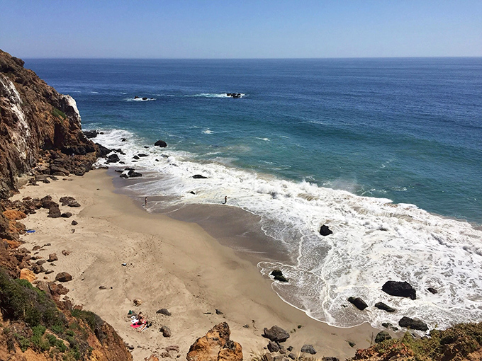 The curve of Point Dume's shoreline looks like nature's perfect smile, with the Pacific's blue waters meeting golden California sand in a timeless embrace.