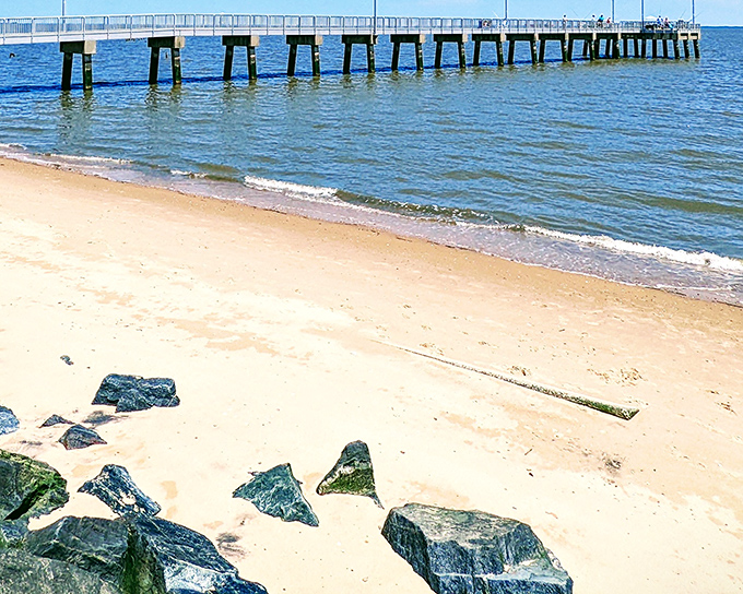 The iconic fishing pier stretches into Delaware Bay like an invitation to adventure, while gentle waves caress the sandy shore below.