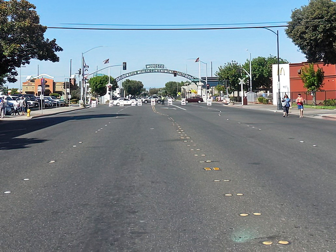 The iconic "Modesto: Water Wealth Contentment Health" arch welcomes visitors to a city where retirement dollars stretch further than your morning yoga routine.