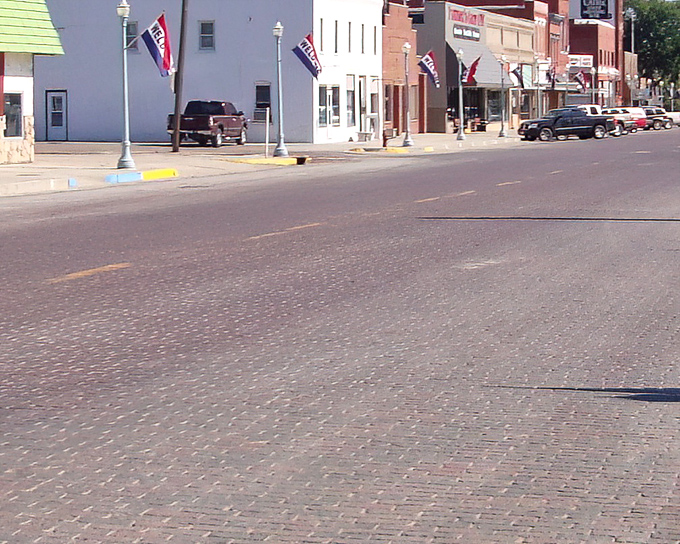 Brick streets that whisper history beneath your tires. Red Cloud's main thoroughfare feels like driving through a time portal where modern life slows to a gentler pace.