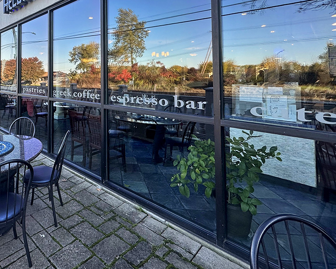 Hellenic Kouzina's inviting espresso bar window reflects autumn colors, promising Greek coffee to complement your Mediterranean feast in Mechanicsburg.