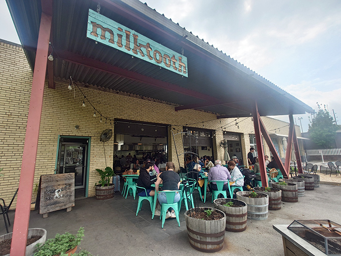 The turquoise sign beckons like a culinary lighthouse, promising delicious refuge in this converted auto garage where brunch dreams come true.