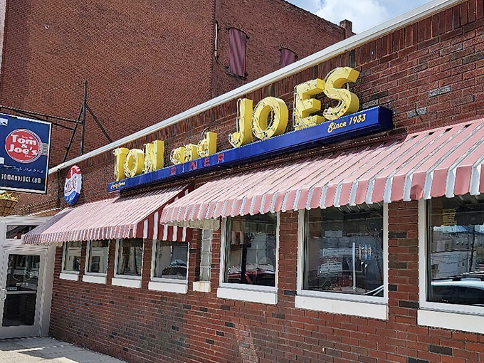 That red and white awning isn't just decoration&mdash;it's a portal to a simpler time when diners served community alongside comfort food.