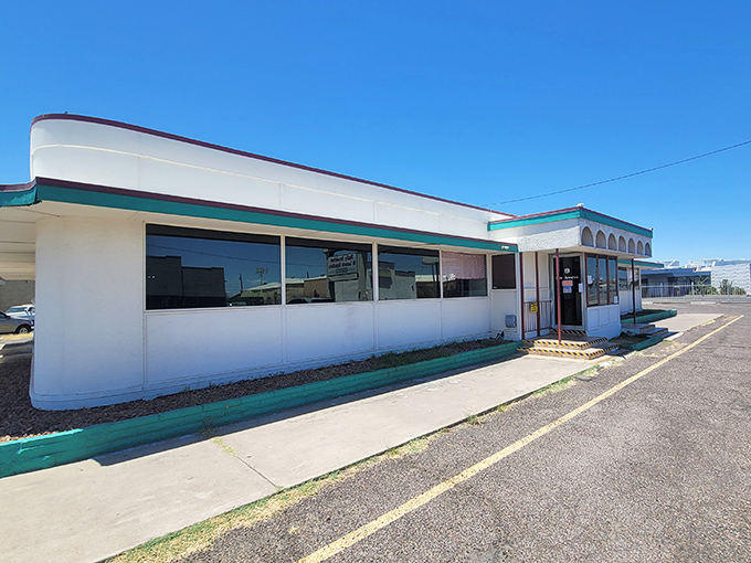 The unassuming exterior of Mel's Diner stands like a time capsule against the Arizona sky, promising comfort food treasures within its teal-trimmed walls.