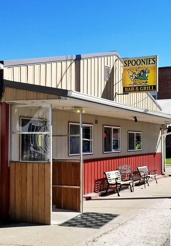 The unassuming exterior of Spoonies Bar & Grill stands proudly against the Illinois sky, proving great food doesn't need fancy architecture to be legendary.