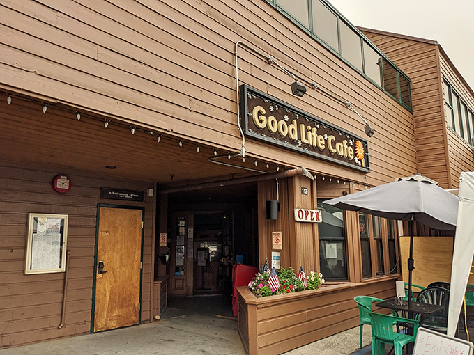 The unassuming wooden exterior of Good Life Cafe proves once again that culinary treasures often hide in plain sight. That sunflower sign promises warmth inside!