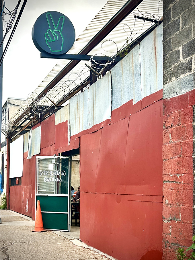The iconic green peace sign beckons pizza pilgrims to this unassuming Fishtown gem. Proof that greatness often hides behind humble facades.