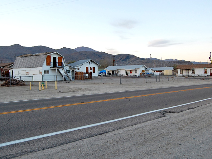 Desert living at its most authentic—modest homes stand sentinel against the dramatic backdrop of mountains that frame this resilient mining community.