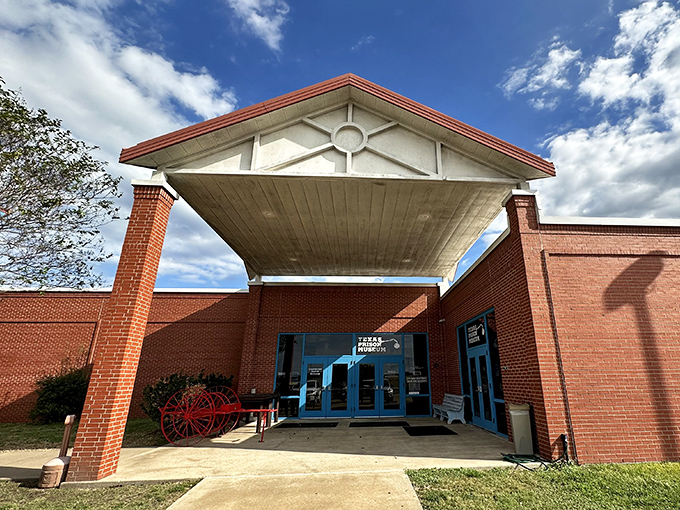 A surprisingly welcoming entrance for a museum dedicated to such a serious subject&mdash;complete with a vintage red wagon that hints at stories within.