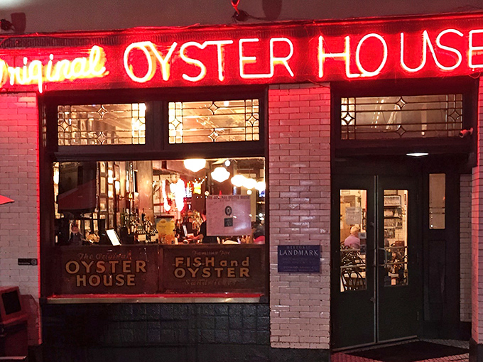 The red neon glow beckons like a lighthouse for landlocked seafood lovers seeking oceanic treasures.