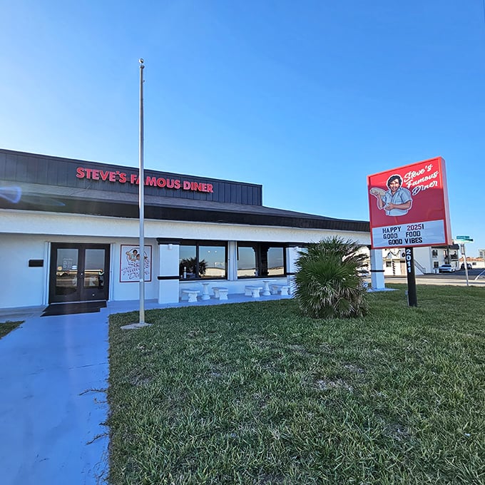 Steve's Famous Diner stands proudly against the Florida sky, its red sign promising "Happy Food, Good Vibes" – a roadside beacon for hungry travelers.