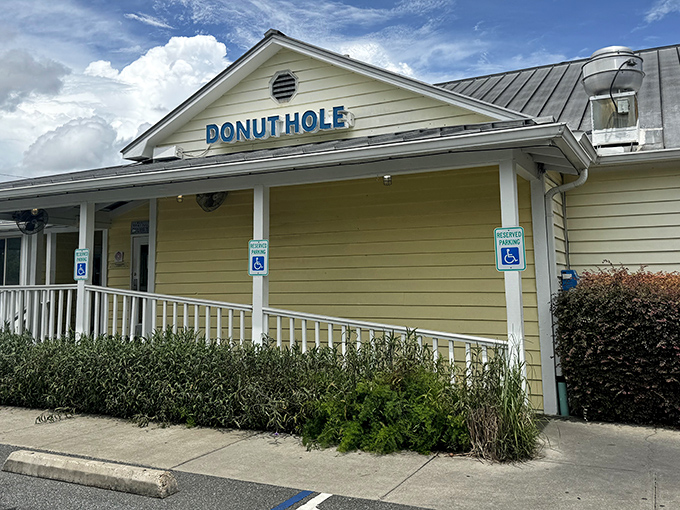 The cheerful yellow exterior of Donut Hole beckons like a sunrise, promising sweet beginnings to your day in Santa Rosa Beach.