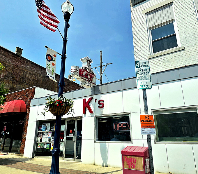 The iconic chef sign beckons hungry travelers like a culinary lighthouse. This white-fronted time capsule on Troy's Main Street promises simple perfection inside.