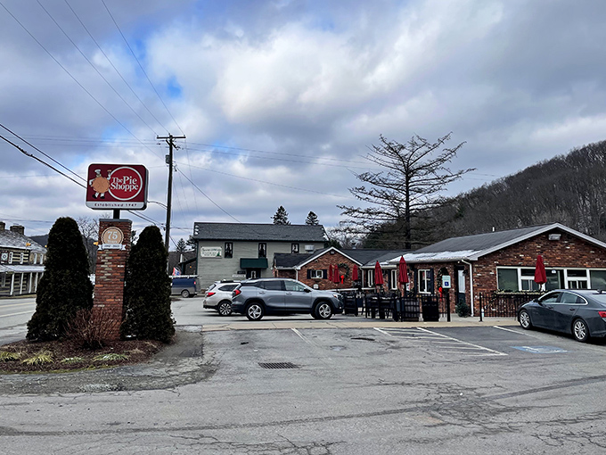 The brick façade of The Pie Shoppe stands like a humble temple to pastry perfection, complete with flower boxes that say "We care about details—just wait till you taste the pie."