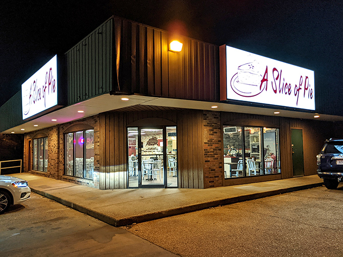 The humble exterior of A Slice of Pie glows like a beacon in the night, promising sweet salvation for dessert lovers passing through Rolla.