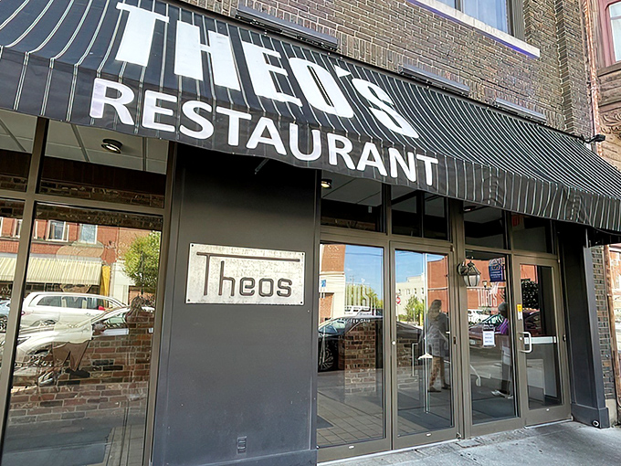 The unassuming black awning of Theo's Restaurant stands as a beacon for hungry travelers &ndash; Cambridge's culinary landmark hiding in plain sight.