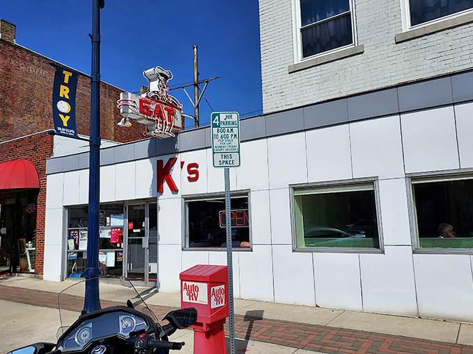 The iconic white-tiled exterior of K's Hamburger Shop stands as a beacon of culinary tradition in downtown Troy, complete with that unmistakable vintage "EAT" sign.