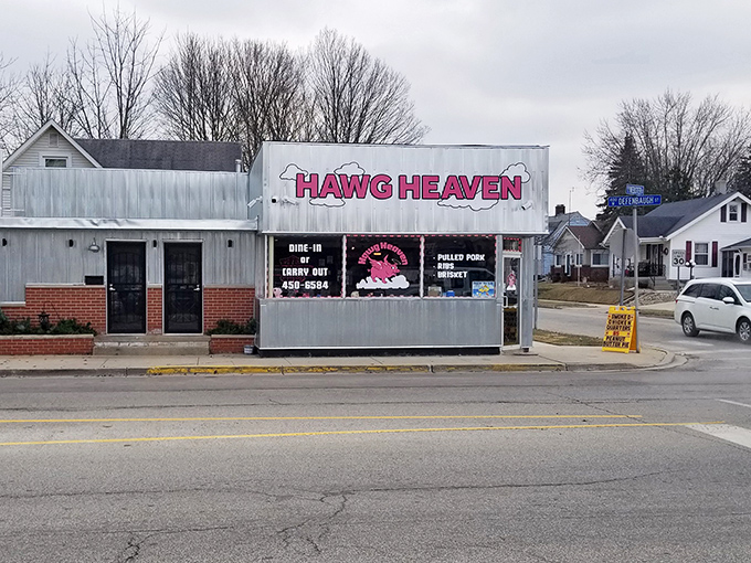 The unassuming exterior of Hawg Heaven stands like a beacon of barbecue hope on Kokomo's Defenbaugh Street, promising smoky delights within its humble walls.