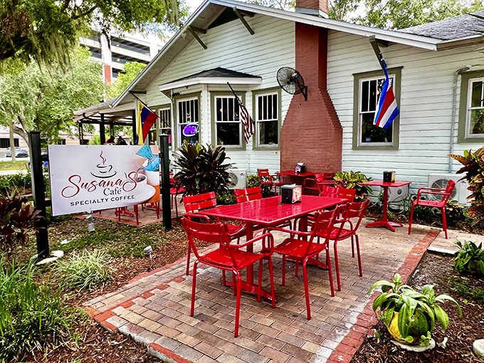 A charming white bungalow with eye-catching red outdoor furniture that practically screams "sit here, stay awhile!" Susana's welcoming exterior is Florida casual perfection.