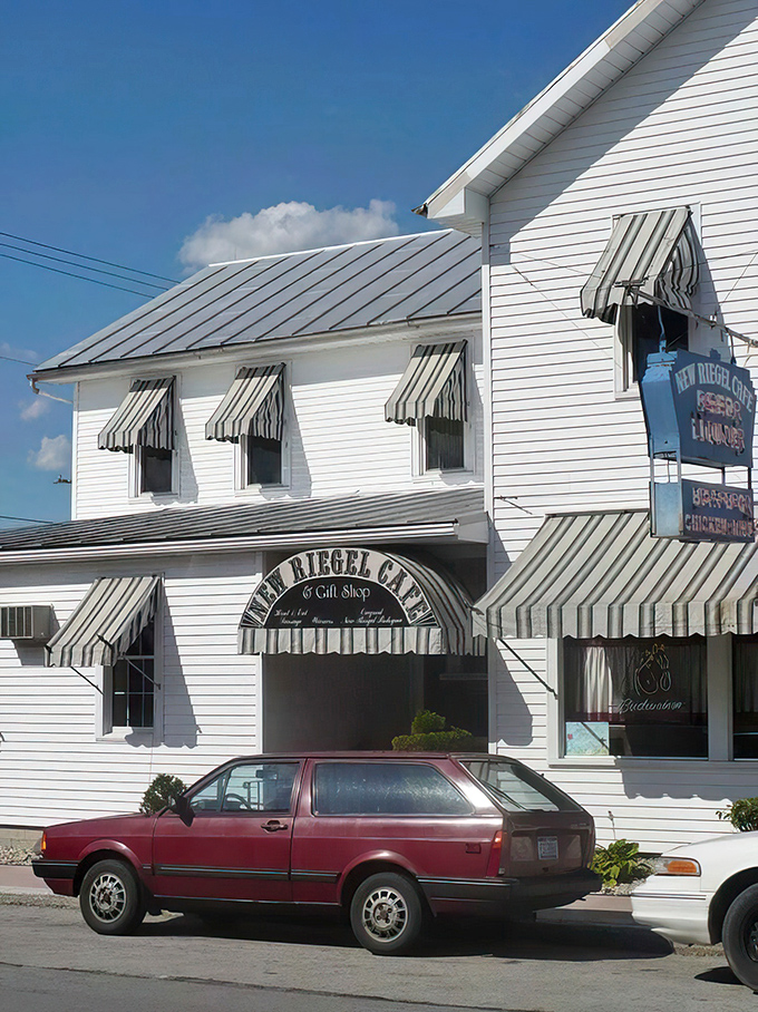 The classic white clapboard exterior of New Riegel Cafe stands like a time capsule in rural Ohio, complete with vintage striped awnings that have sheltered hungry visitors for generations.