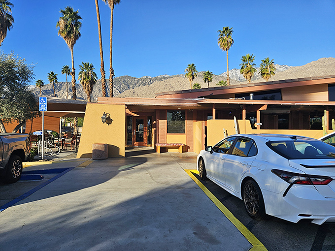 Palm Springs perfection: Elmer's exterior basks in desert sunshine while the San Jacinto Mountains stand guard like hungry sentinels waiting for breakfast.