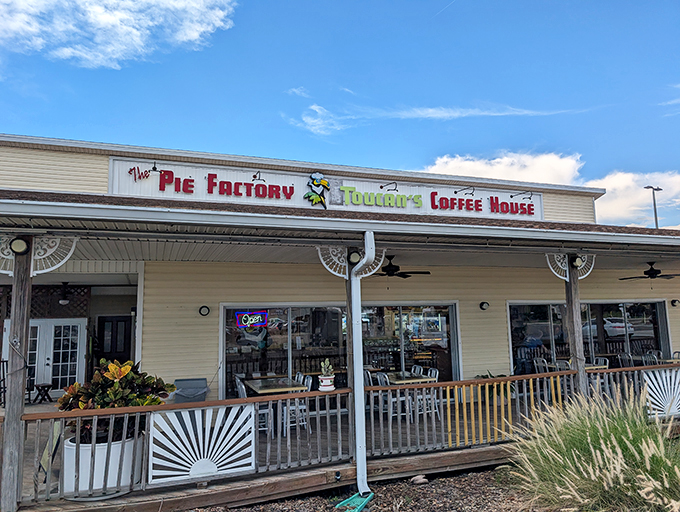 The Pie Factory's cheerful exterior beckons like an old friend inviting you over for dessert. That porch practically whispers, "Stay awhile, calories don't count here."