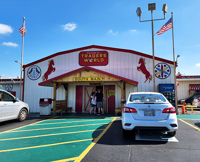 The iconic red and white entrance to Traders World beckons treasure hunters with its distinctive horse silhouettes&mdash;Ohio's retail rodeo where bargains await.