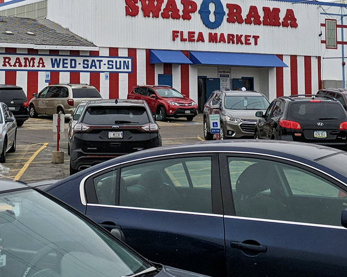 The red and white exterior of Swap-O-Rama beckons like a carnival of commerce, promising treasures waiting to be discovered inside.