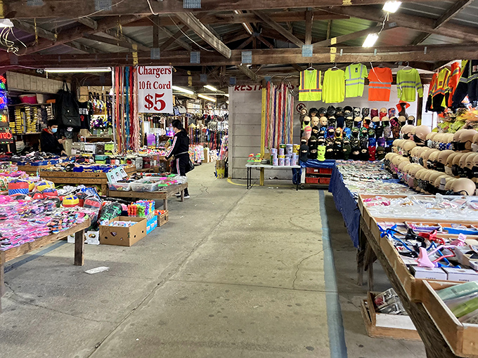 The covered pavilions at US 1 Metro Flea Market buzz with weekend energy as shoppers hunt for treasures among tables laden with colorful merchandise.