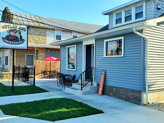 A picturesque patio setup that practically whispers, "Stay awhile, partner." Those red umbrellas have sheltered many a BBQ epiphany.