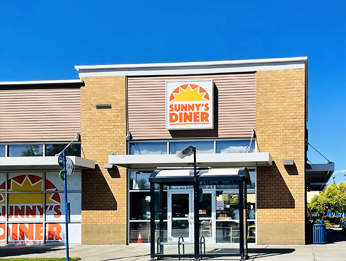 The sunshine-yellow brick exterior of Sunny's Diner stands like a beacon of breakfast hope against Oregon's famously fickle sky.