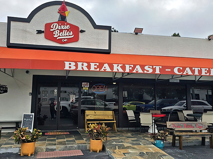 The cheerful red-and-white facade of Dixie Belle's Cafe welcomes hungry travelers like a Southern grandmother ready with a warm hug and hot breakfast.