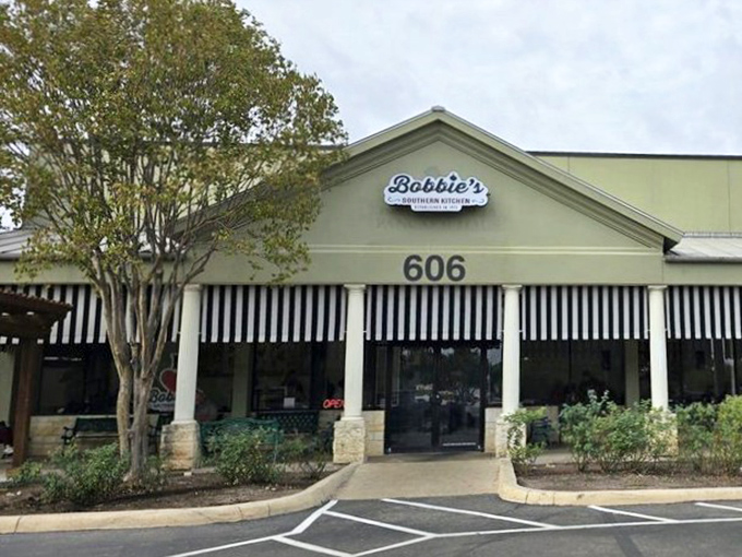 The pale green exterior with classic black and white awnings isn't trying to impress anyone&mdash;it's saving all that energy for what happens in the kitchen.