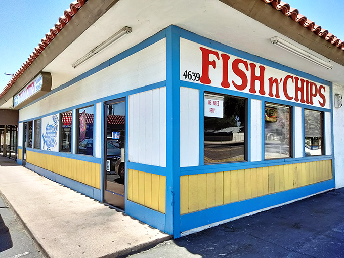 The blue and yellow exterior of West Coast Fish N' Chips stands out like a maritime beacon in Fresno, promising seafood treasures within those unassuming walls.