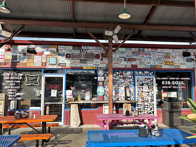 The license plate wall tells a story &ndash; each metal rectangle represents a pilgrim who journeyed to this BBQ sanctuary. The colorful picnic tables await your barbecue revelation.