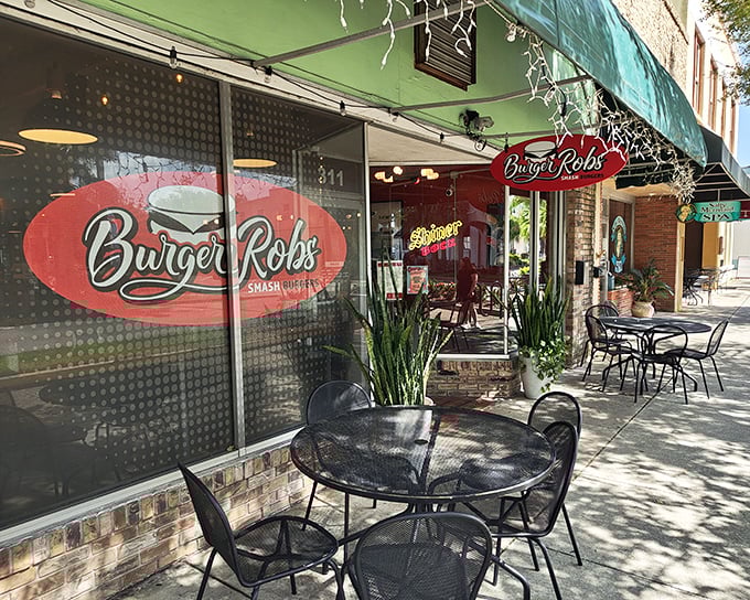BurgerRobs' vibrant red exterior isn't just a building—it's a beacon of hope for the burger-deprived souls of Titusville. Outdoor seating awaits.