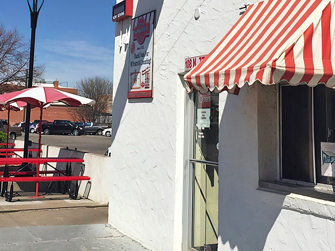 That classic red and white awning isn't just decoration&mdash;it's a portal to a simpler time when burgers were small and satisfaction was huge.