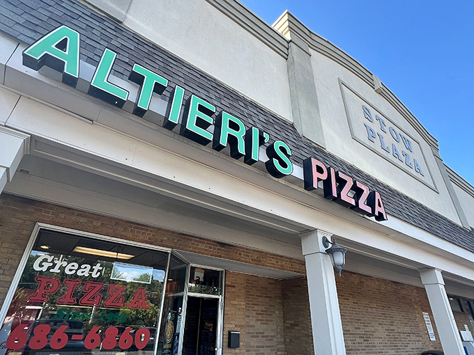 The teal and pink sign of Altieri's Pizza stands out like a beacon of hope for the hungry in Stow's strip mall landscape.