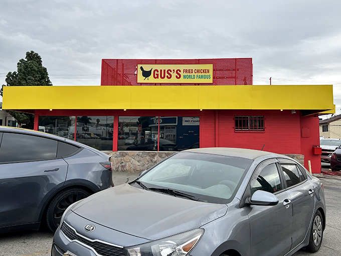 The red and yellow facade of Gus's isn't just eye-catching&mdash;it's a beacon of hope for fried chicken enthusiasts everywhere. That yellow door promises delicious secrets within.