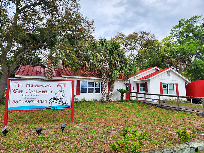 Like a maritime welcome committee, the cheerful sign and palm trees greet hungry visitors. This isn't South Beach glitz—it's authentic Florida Gulf Coast charm that promises honest seafood.