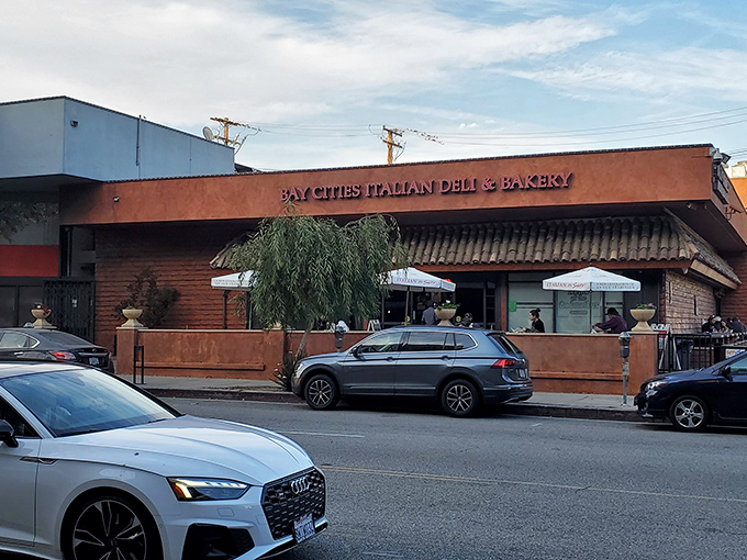 The unassuming terra-cotta exterior of Bay Cities hides culinary treasures within. Like finding a Lamborghini parked in a suburban garage&mdash;unexpected brilliance awaits.