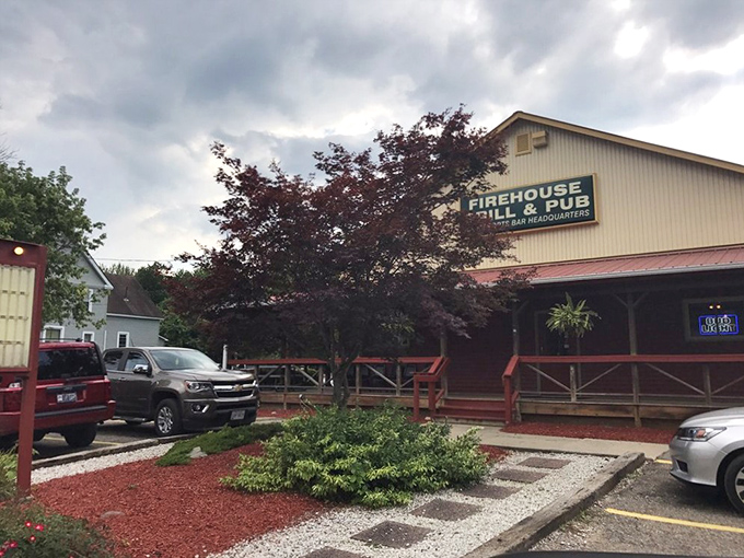Summer reveals the Firehouse in all its glory, with vibrant landscaping and a sign that beckons like a lighthouse for the hungry traveler.