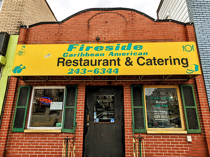 The bright yellow sign against red brick is like a Caribbean sun beaming through Pittsburgh's urban landscape—impossible to miss and impossible to resist.