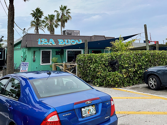 The turquoise exterior of 12A Buoy stands out like a tropical oasis, promising seafood treasures within its unassuming walls.